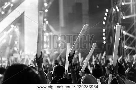 Crowd of hands up glow stick concert stage lights and people fan ...