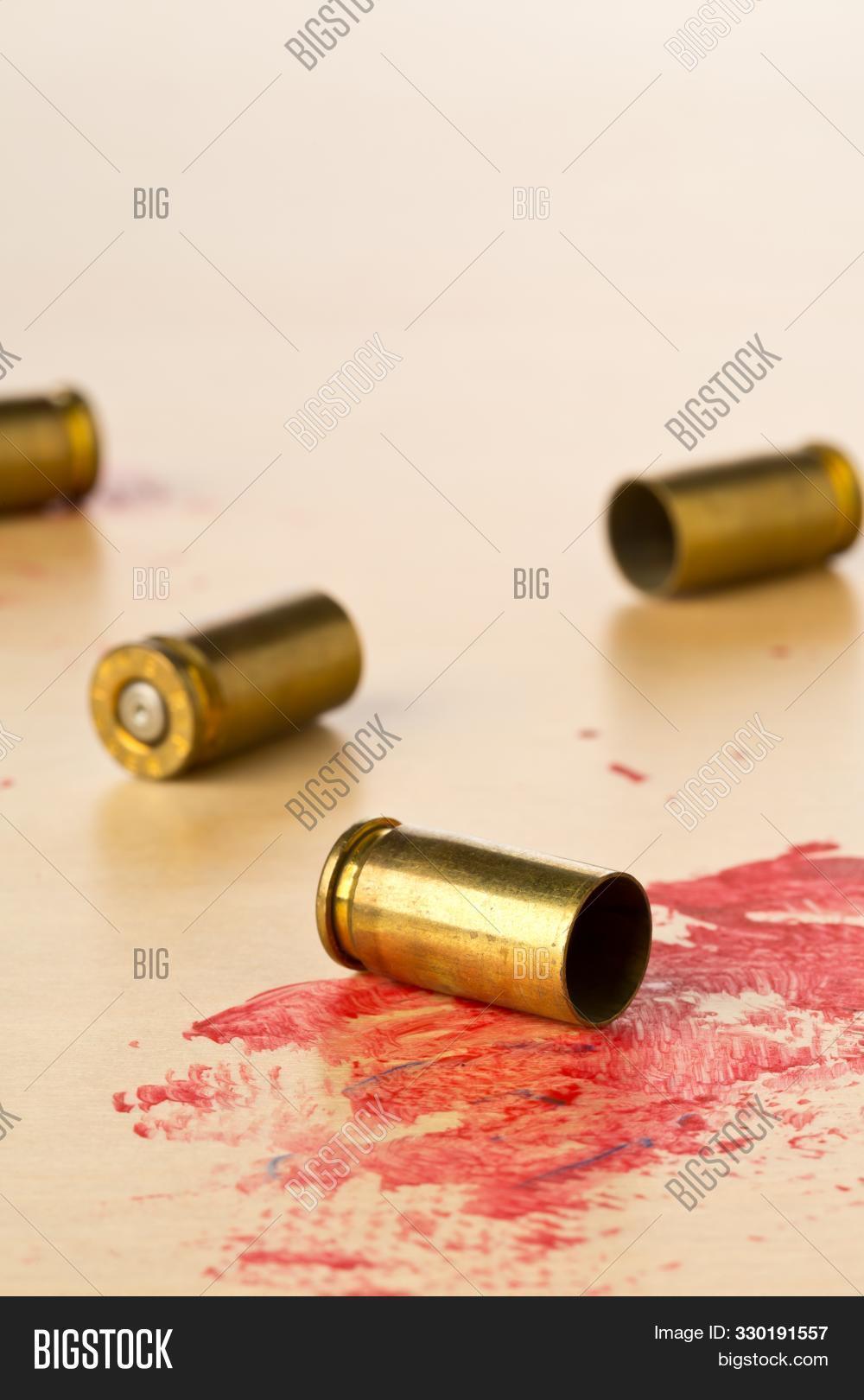 Empty, Fired, Blood Covered 9mm Bullet Casings On Wooden Floor ...
