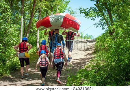 A Group Of Sportsmen In Sports Equipment After A Successful Rafting ...