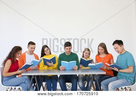 Group of people reading books while sitting at table - Stock Image ...