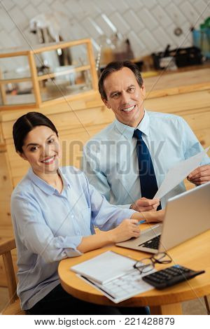 Work atmosphere. Pleasant clever stylish workers sitting together in ...