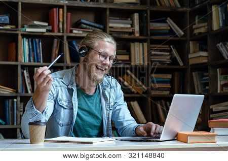 Smiling Happy Young Man Wear Headset Look At Laptop Screen Study In ...