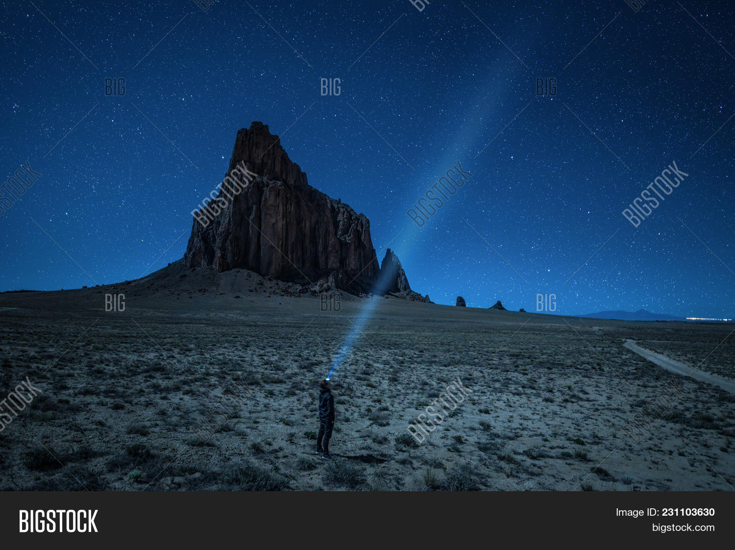Hiker With A Head Lamp Under The Night Sky With Many Stars Near ...