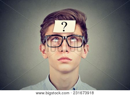 Thinking Man With Question Mark Looking Up On Gray Wall Background ...
