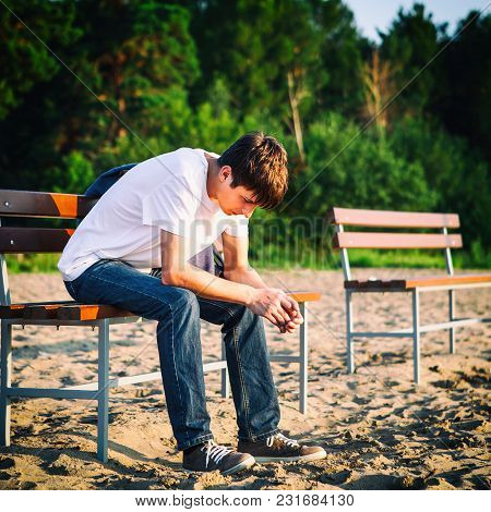 Sad Guy Sit On The Bench Outdoor image & stock photo. 231684130