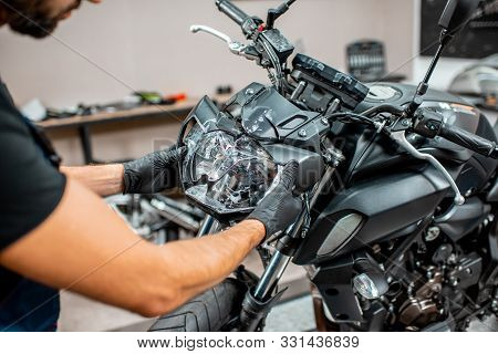 Worker Removing Broken Headlight After The Accident, Repairing ...
