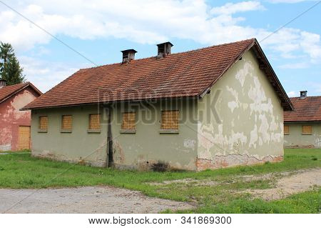Green Small Dilapidated Military Barrack Building With Boarded Windows ...