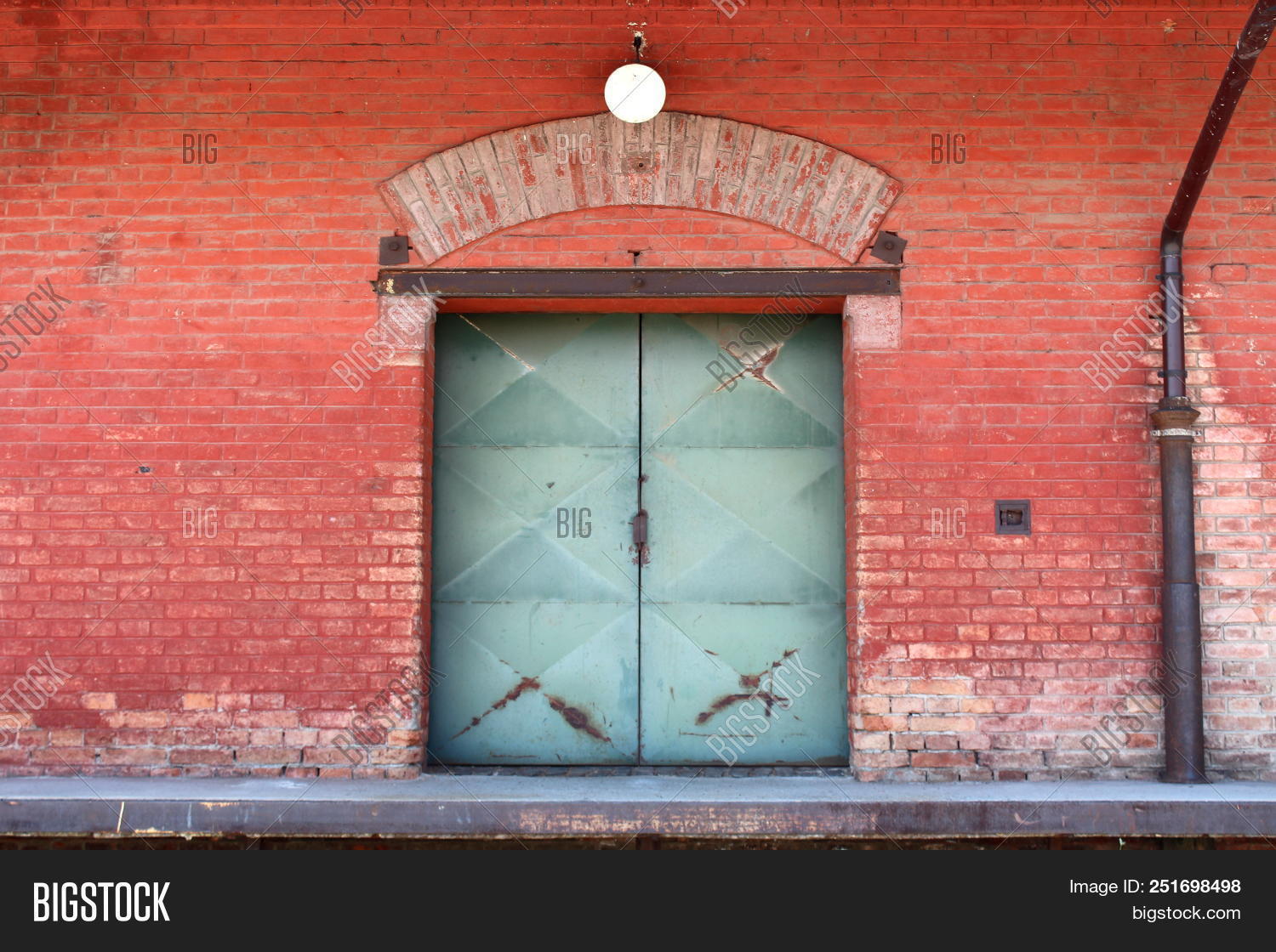 Strong Green Rusted Metal Doors On Red Brick Building Connected To ...