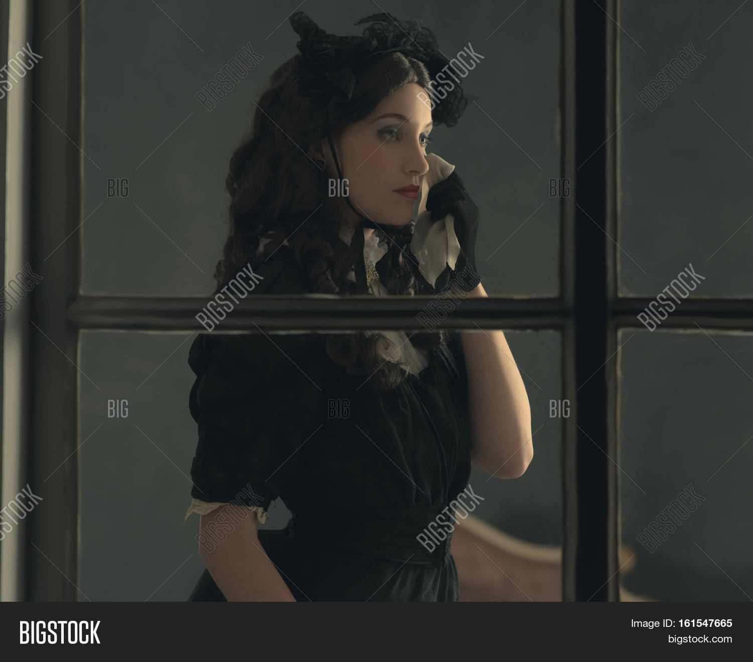 Sad Retro Victorian Woman In Black Dress Wiping Tear Standing Behind ...