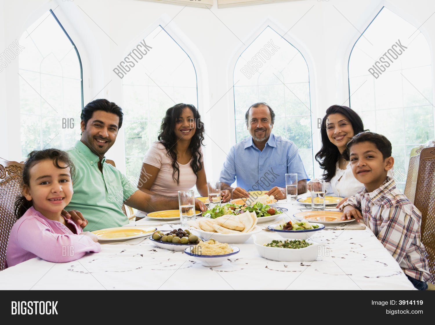 Middle Eastern Family Sat Around Table Eating Food image & stock photo ...