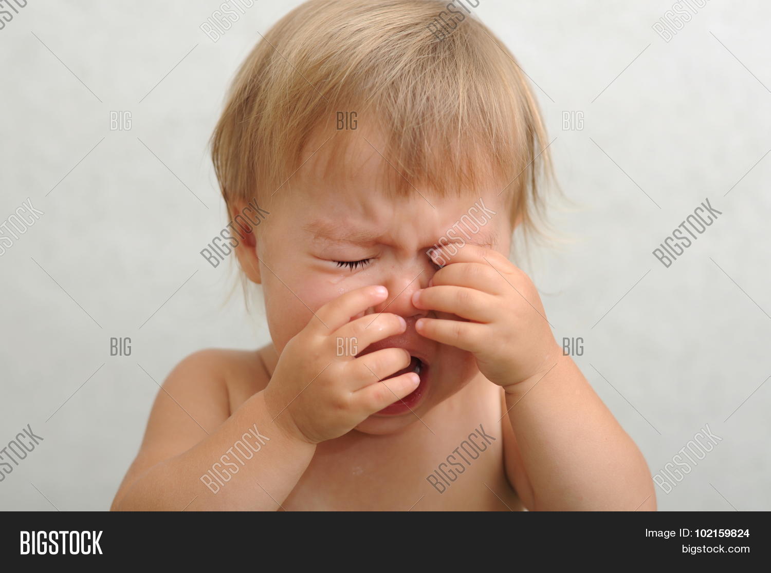 Crying Baby Rubbing Her Eyes image & stock photo. 102159824
