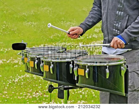 Drumkit and hands of the playing drummer on the clover field. - Stock ...