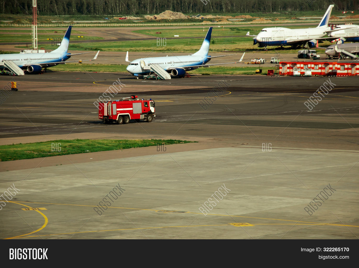 Fire Truck On The Runway Near The Aircraft. Airport Rescue Service ...