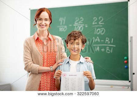 Red-haired Teacher Smiling And Hugging Her Clever Pupil - Stock Image ...