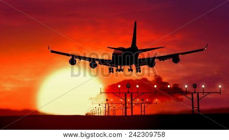 Airplane Silhouette Of Jumbo Jet Lands At The Airport During Sunset ...