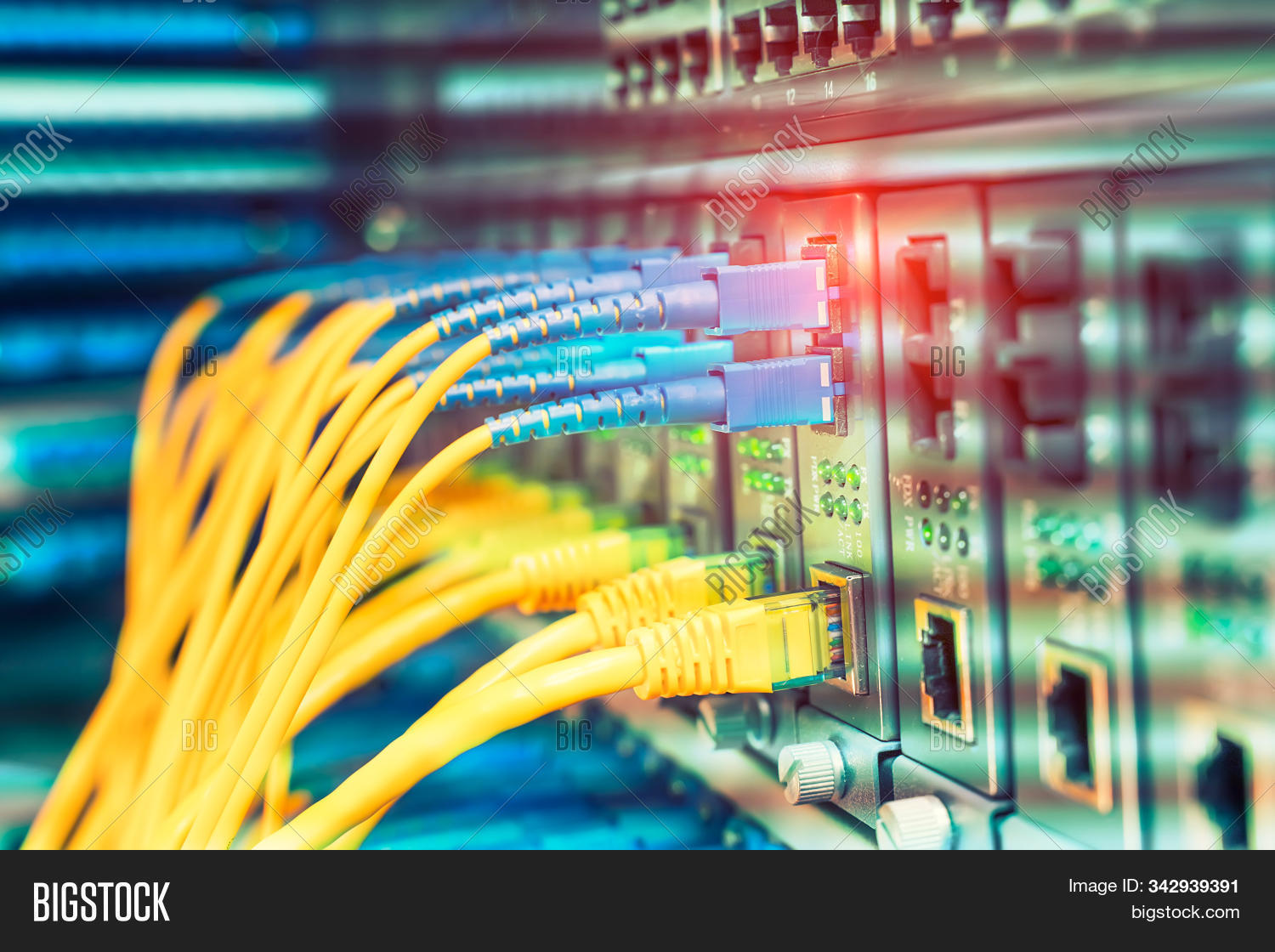 Fiber Optic cables connected to an optic ports and Network cables ...