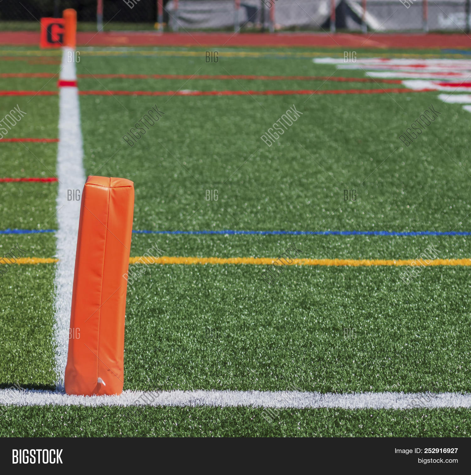 The End Zone Of A Football Field Is Marked With Orange Pylons. image ...