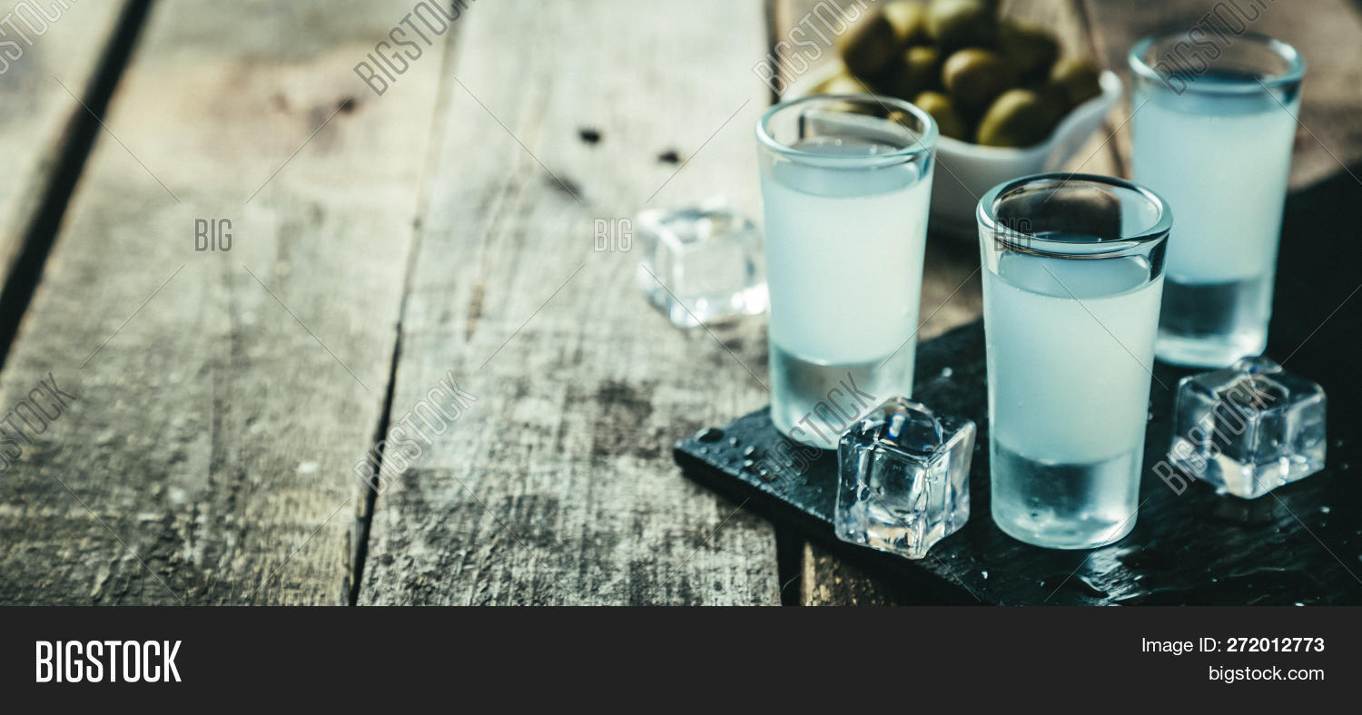 Traditional Greek Vodka - Ouzo In Shot Glasses On Rustic Wood ...