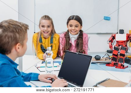 Schoolchildren Programming Robot Together And Using Laptop During Stem ...