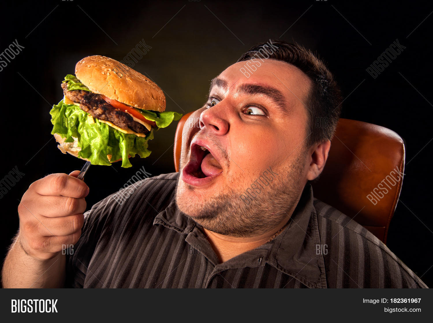 Diet failure of fat man eating fast food hamberger. Happy overweight ...