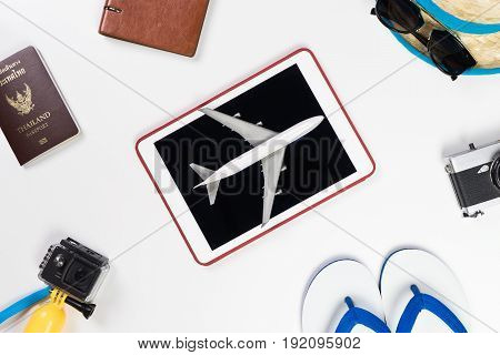 Air plane on tablet surrounded by travel accessories - Stock Image ...