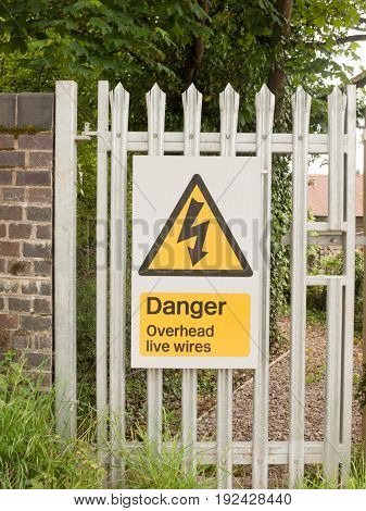 an electric safety sign outside on metal gate with electric bolt in ...