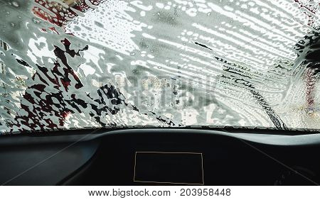 Washing windshield screen of modern car, view from inside - Stock Image ...