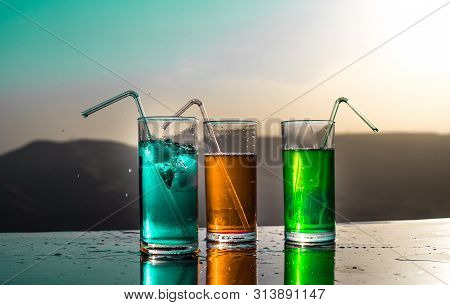 Cooling Summer Drink Concept. Cocktail Glasses Splashing On Sunset ...
