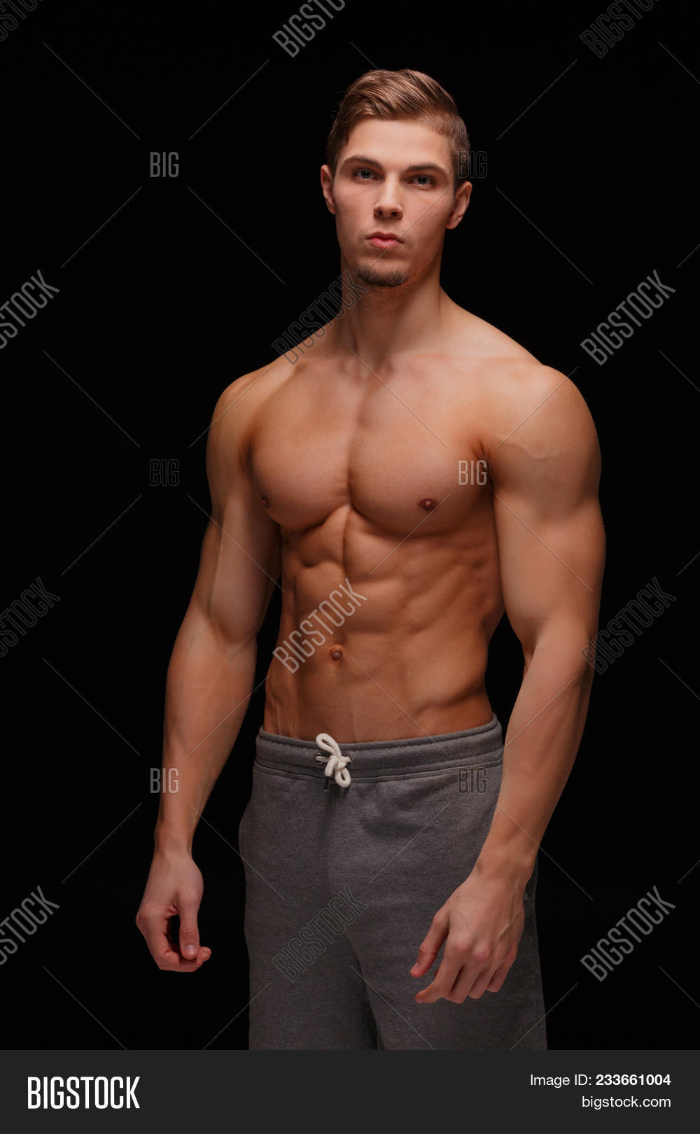 Strong, Muscular Handsome Man Showing Off His Biceps On A Black ...