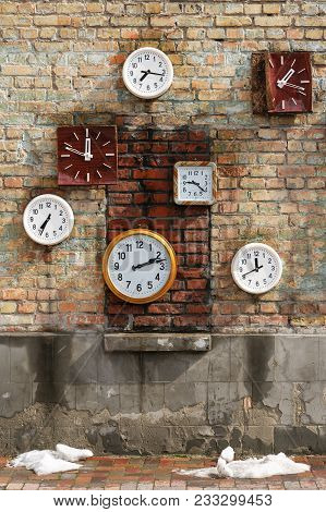 Wall Clock On A Brick Wall. Many Different Hours. Collection Of Wall ...