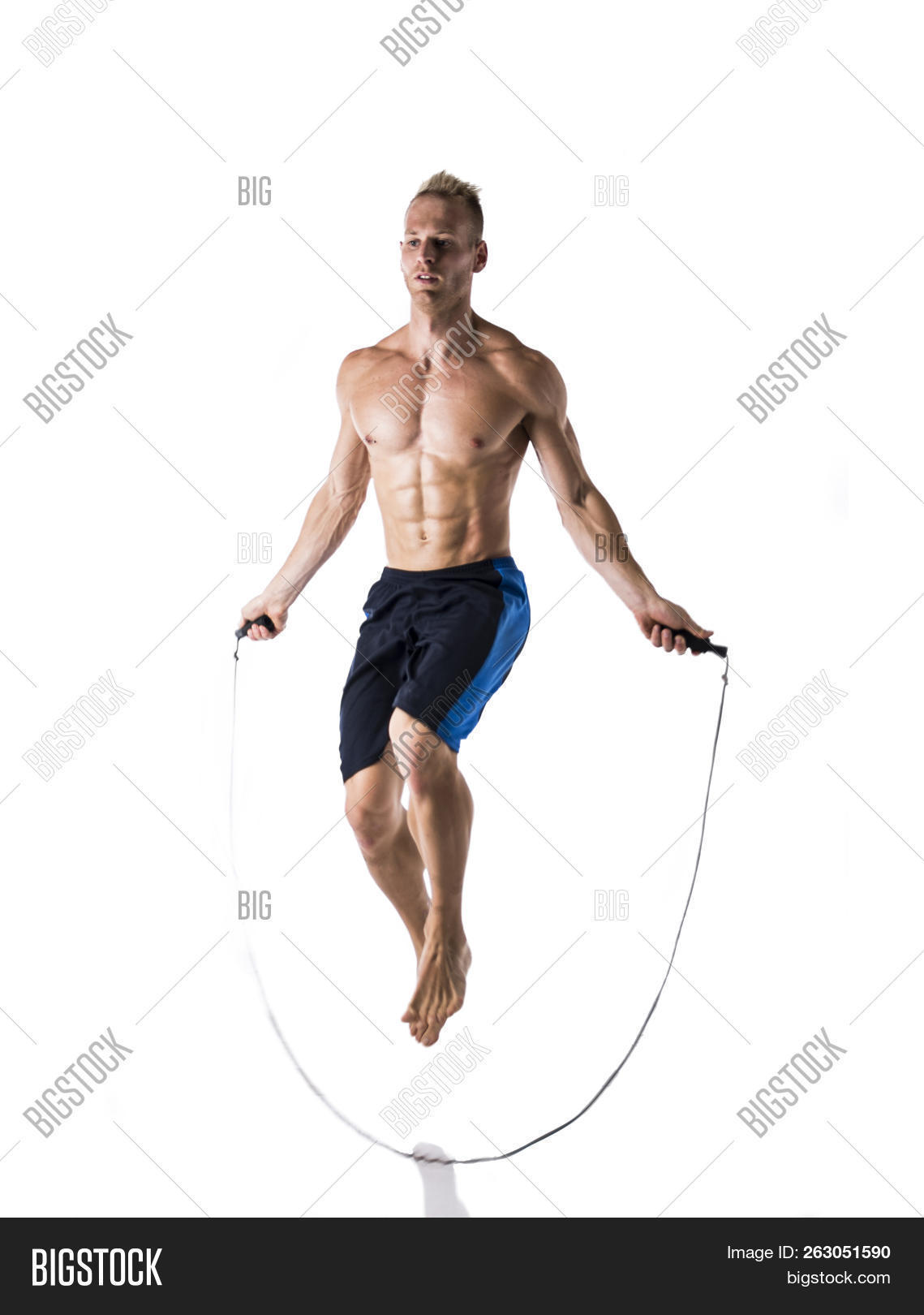 Shirtless Muscular Man Jumping Rope In Studio image & stock photo ...
