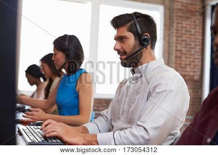 Staff Working In Busy Customer Service Department Shot - Stock Image ...