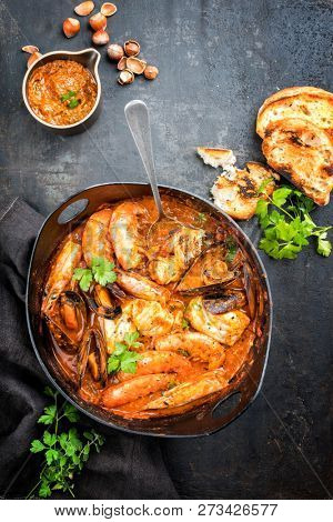 Traditional Catalan fish stew romesco de peix with prawns, mussels and ...