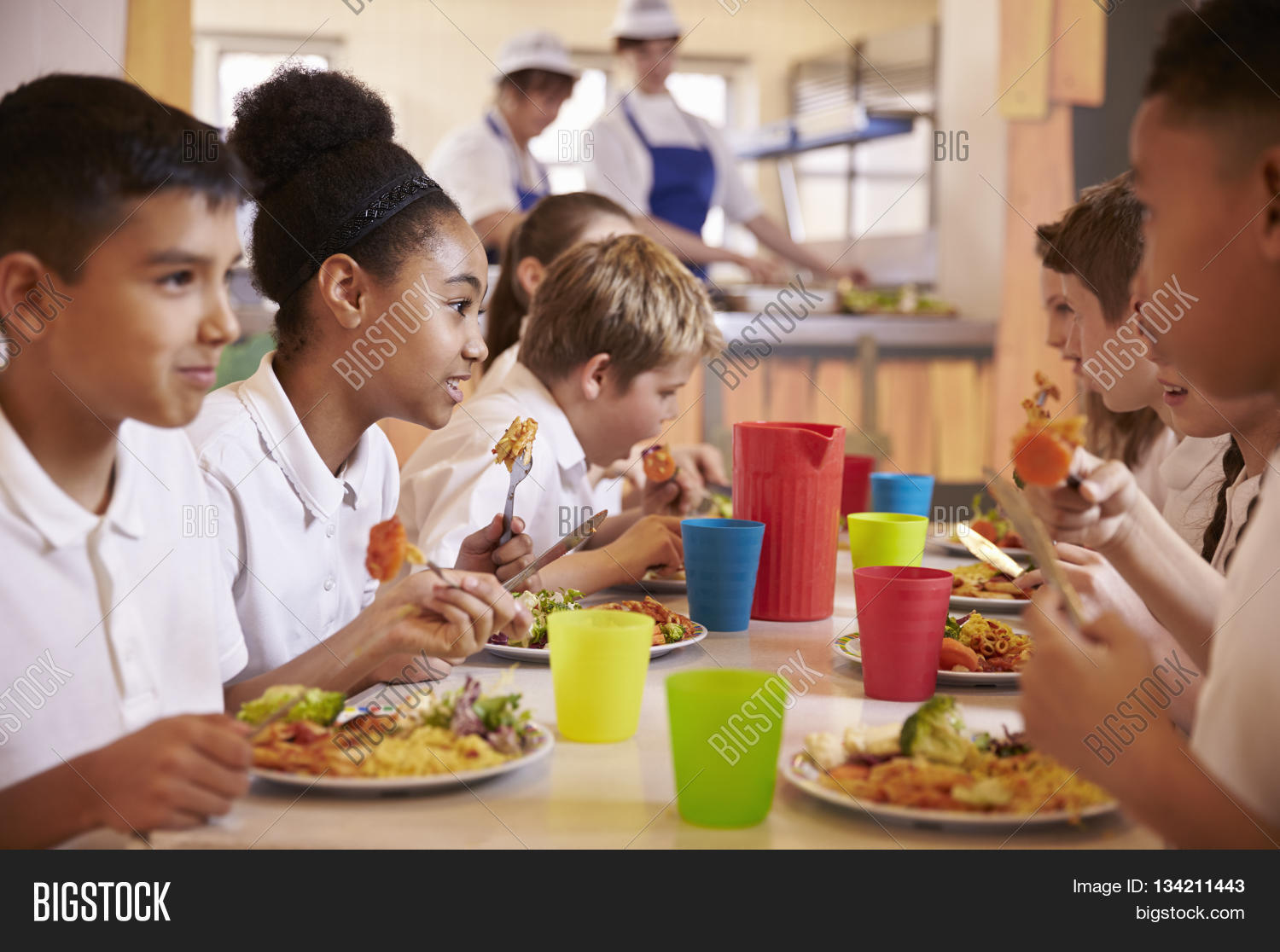Primary school kids eat lunch in school cafeteria, close up image ...