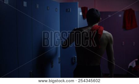 Disappointed And Tired Sportsman In Semi Lit Locker Room. Sad Athlete ...