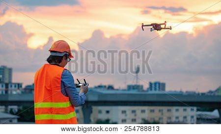 Young Asian Engineer Man Flying Drone Over Construction Site During ...