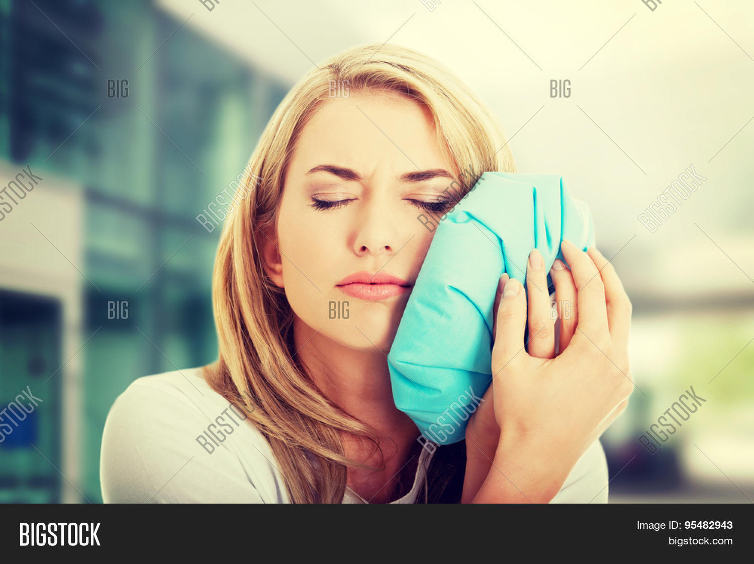 Woman with tooth ache holding an ice bag near her face image & stock ...