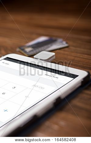 Credit card payment on a swipe or chip reader app on a tablet used by ...