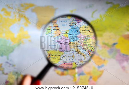 Close up of blurred magnifier above world map. Detail of Europe ...
