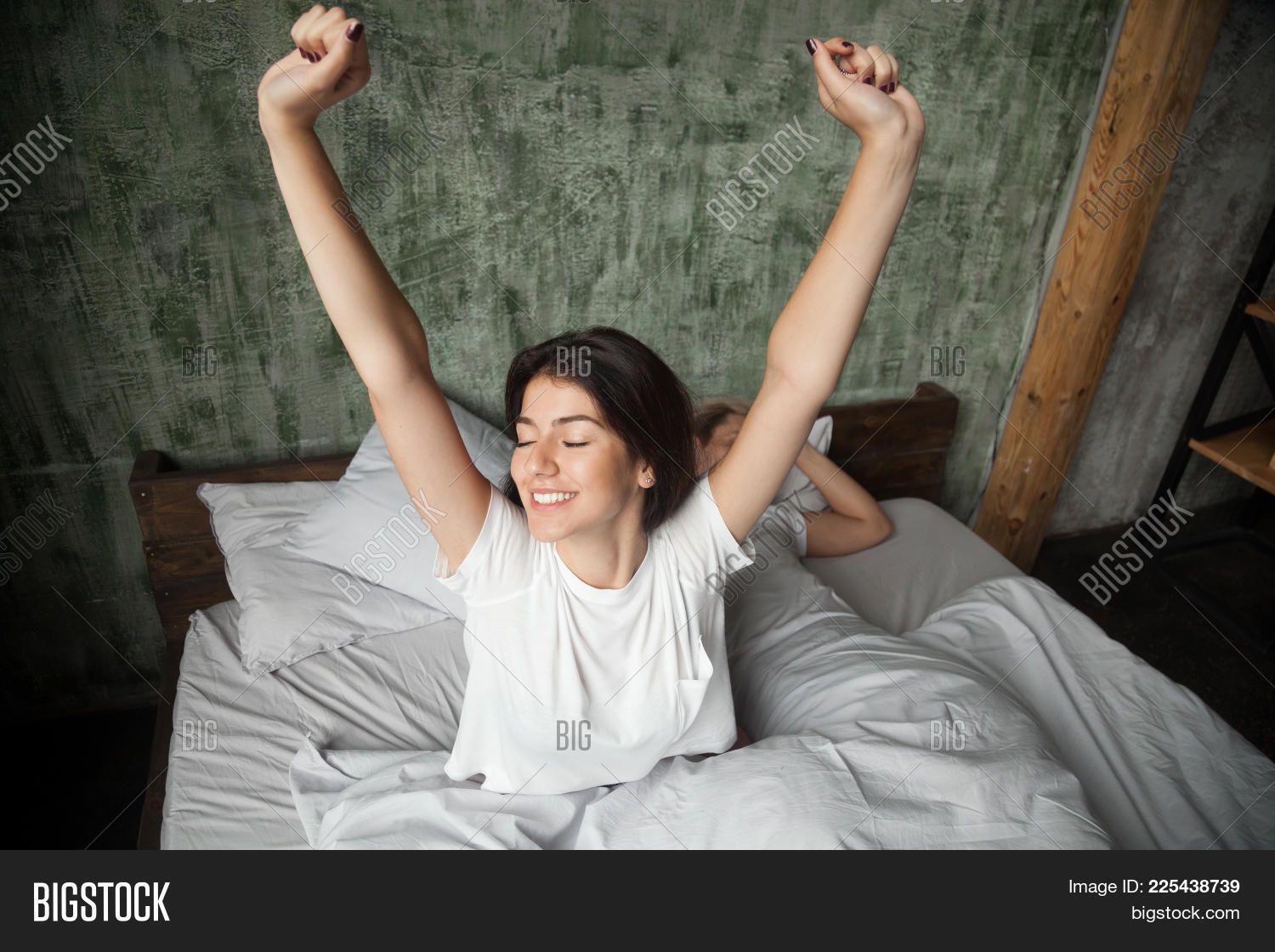 Young Smiling Woman Waking Up Happy After Healthy Sleep Stretching On ...