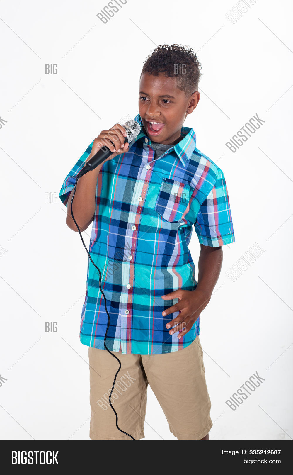 Talented young diverse singer singing into a microphone. Cute African ...