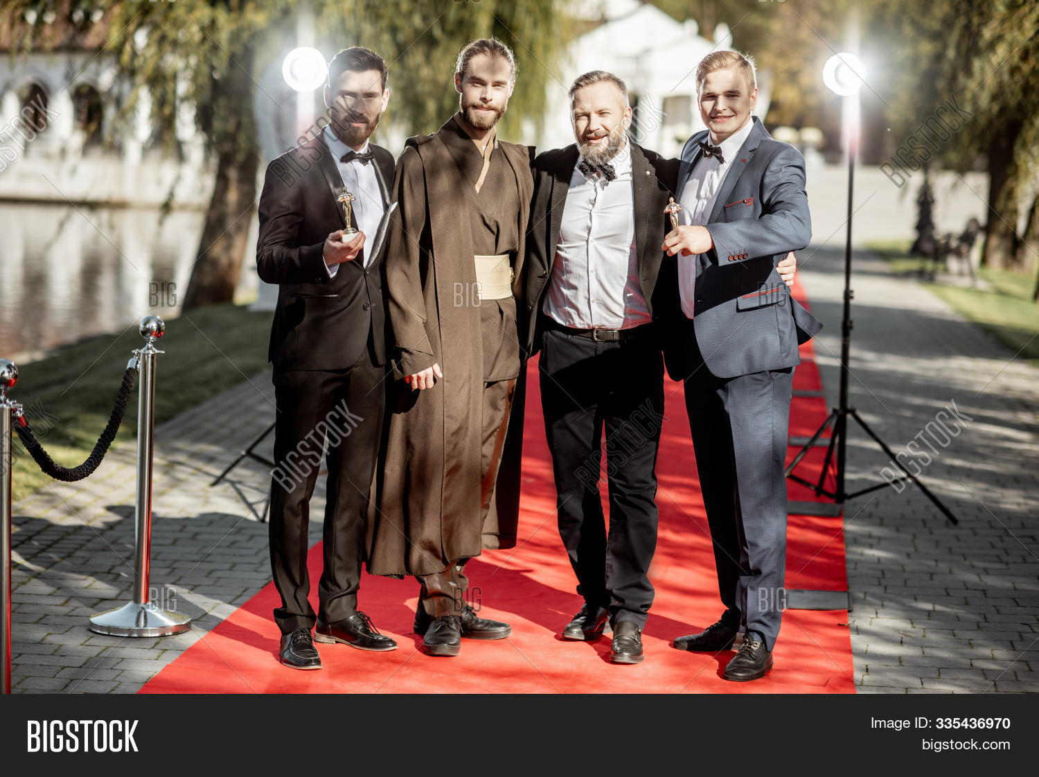 Group portrait of a men as a famous movie actors standing together on ...