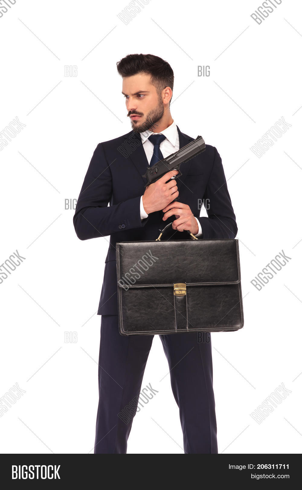young elegant assasin holding gun and suitcase looks to side on white ...