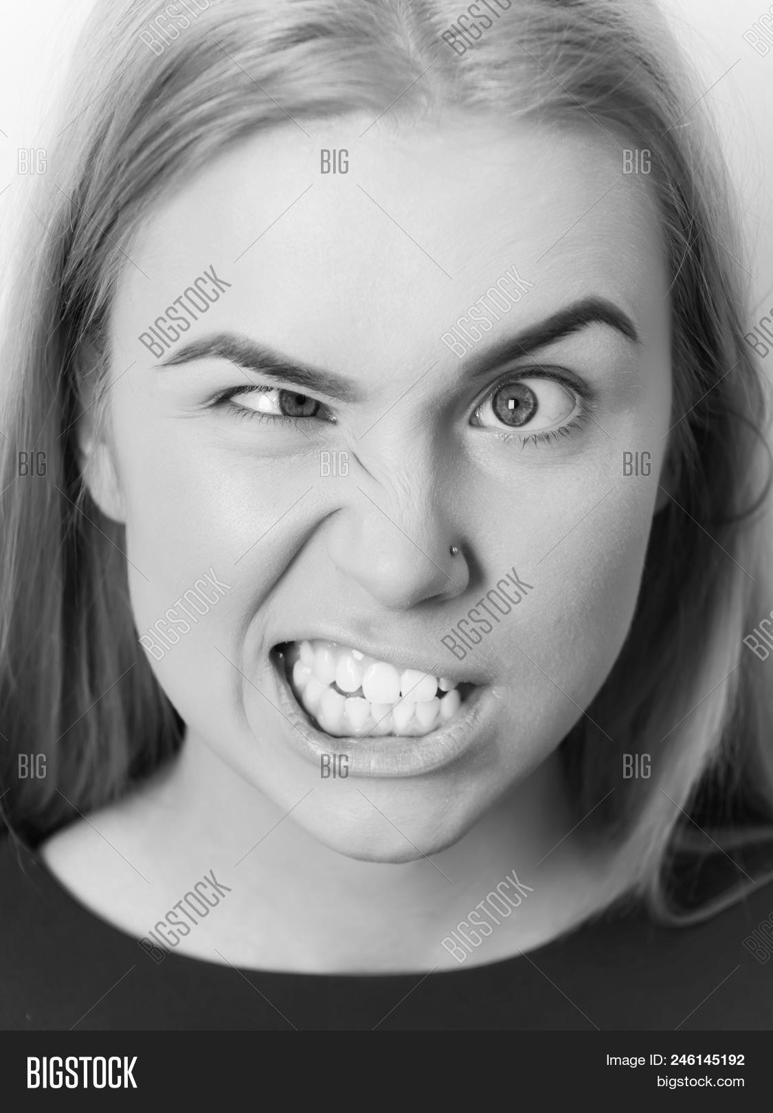 Girl Is Yelling At The Camera. Woman Squinting Eyes On Silly Face With ...