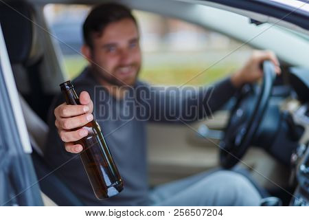 A Tipsy Man In The Car. Man Drinking Alcohol While Driving The Car ...
