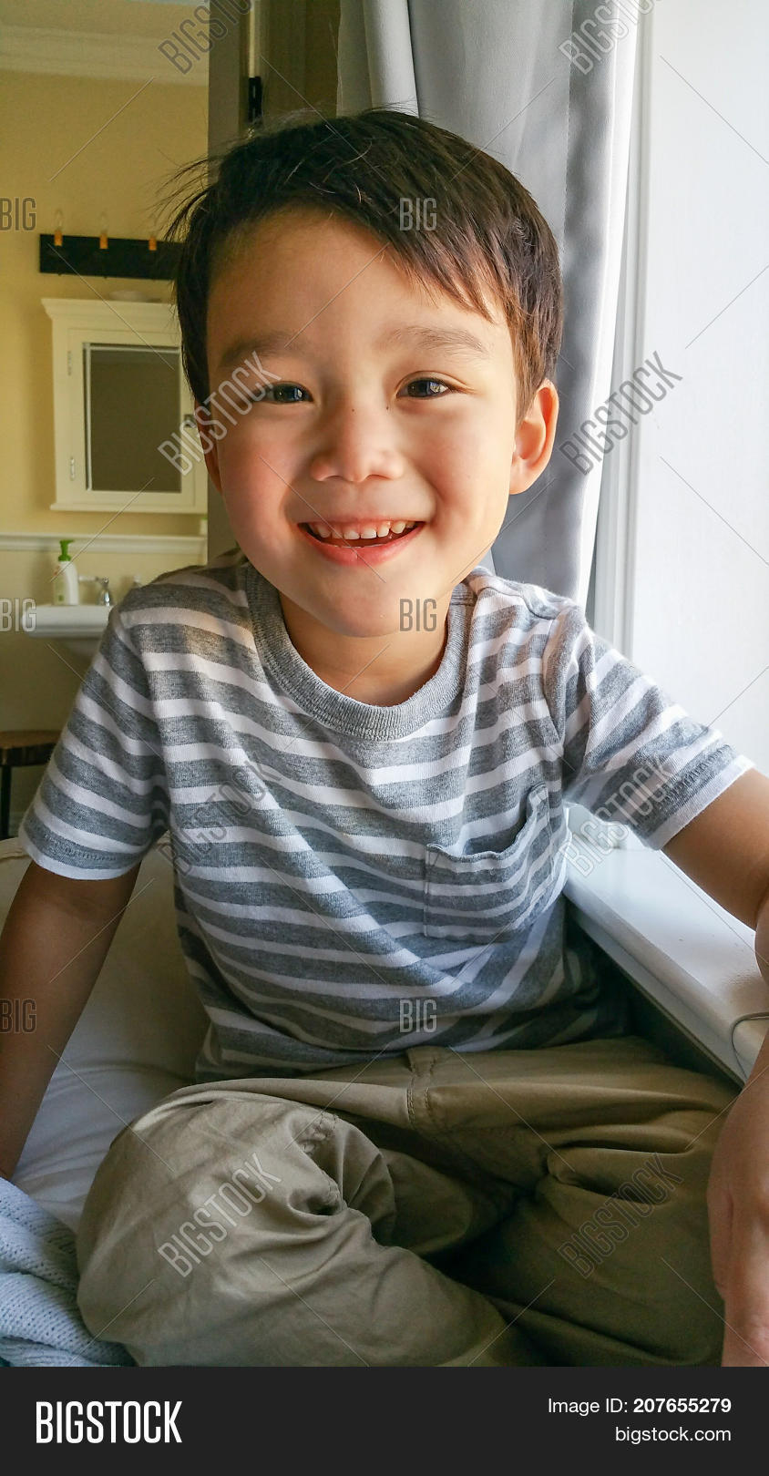 Happy Cute Young Chinese and Caucasian Boy Sitting Near Window. image ...