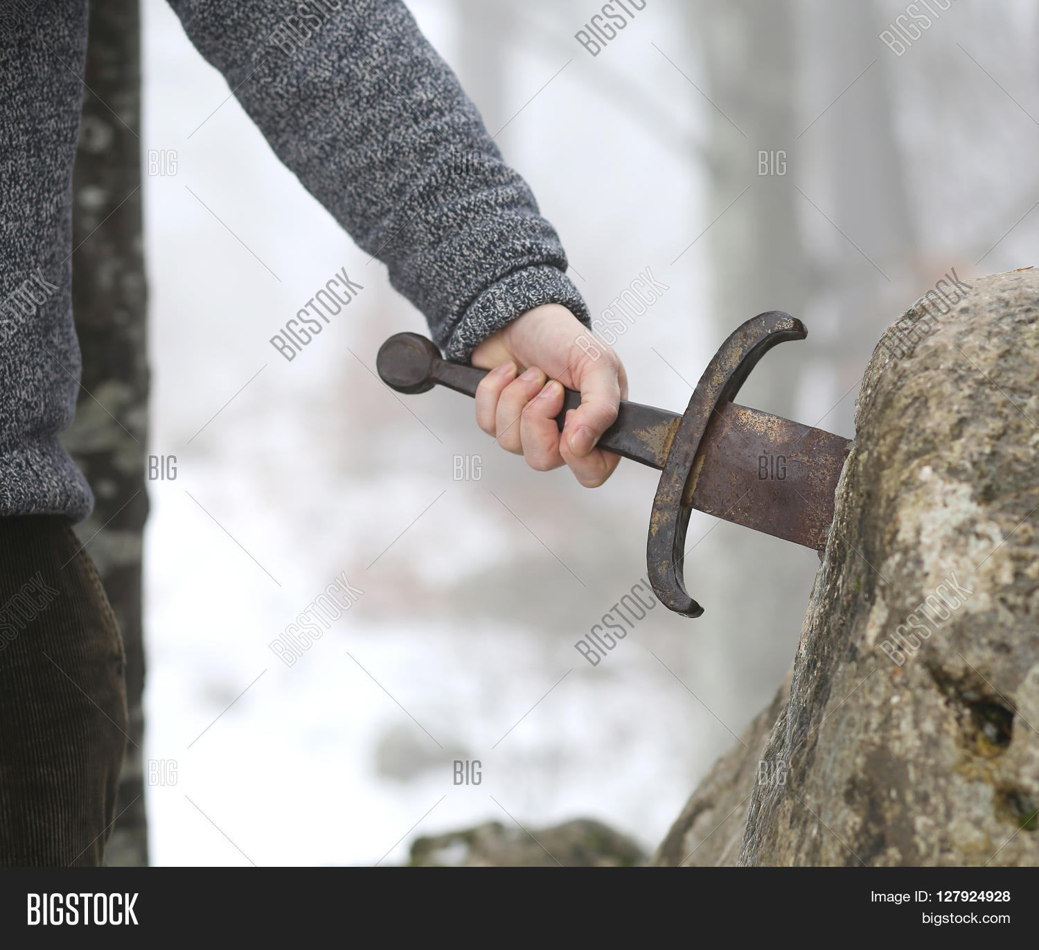 Knight Tries To Remove Excalibur Sword In The Stone image & stock photo ...