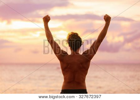 Happy strong man with arms up in success. Silhouette of fit male ...