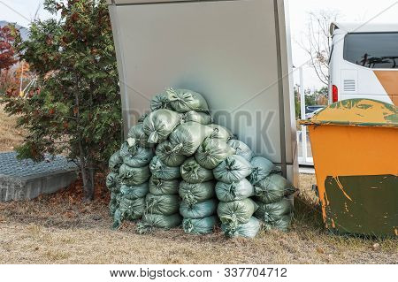 Stacked Of Green Sacks At The Side Of A Parking Area - Stock Image ...