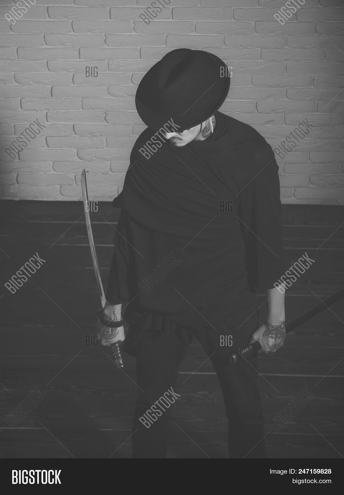 Brutal Gangster In Tattoos. Warrior In Black Hat And Clothes, Top View ...